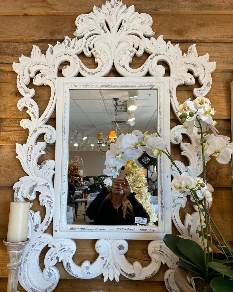 This gorgeous white wash mirror, with scrolls, is 52.5” tall. A ...
